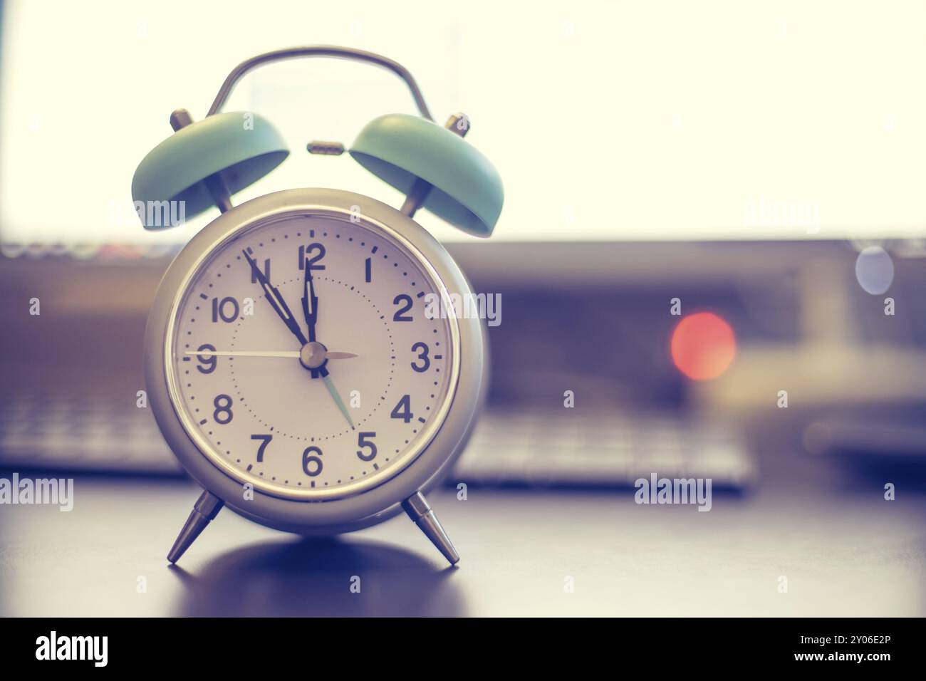 Alarm clock on the desk, office stuff in the blurry background ...