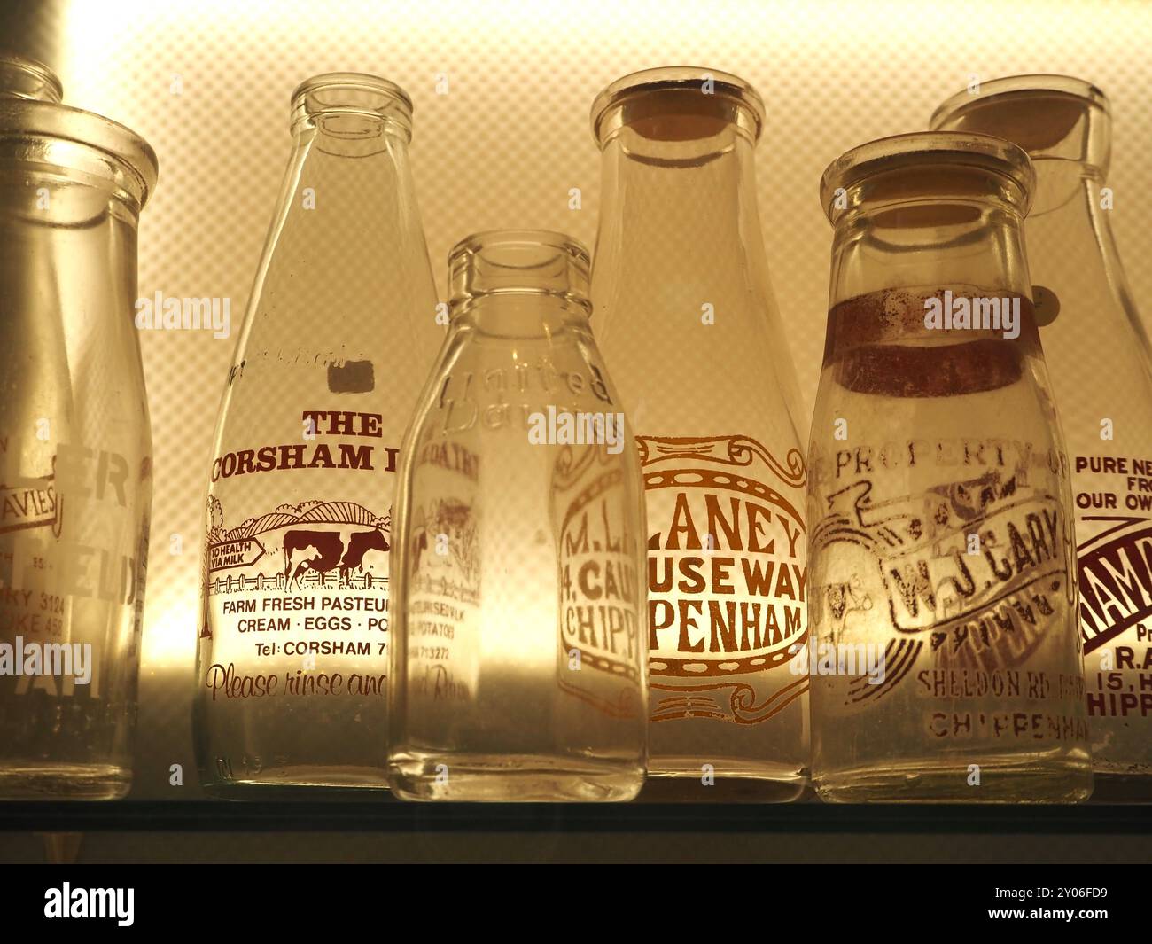 Selection of vintage glass milk bottles bearing name or names of dairy ...