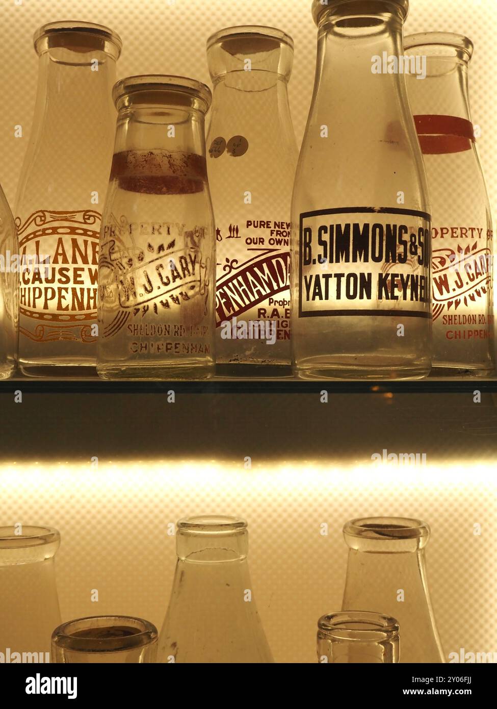 Selection of vintage glass milk bottles bearing name or names of dairy ...
