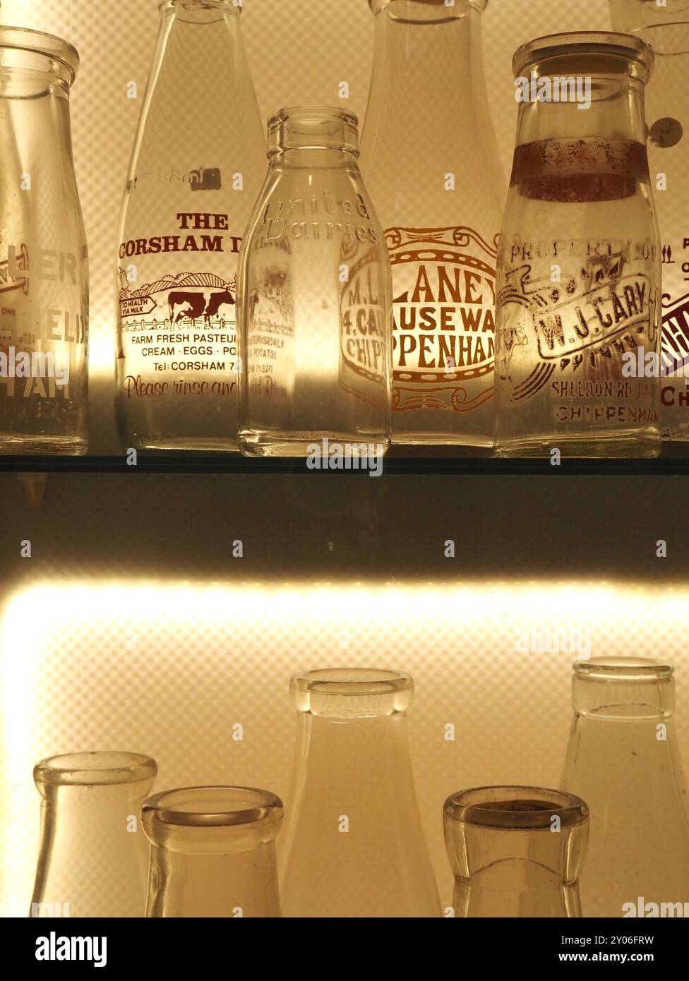 Selection of vintage glass milk bottles bearing name or names of dairy ...