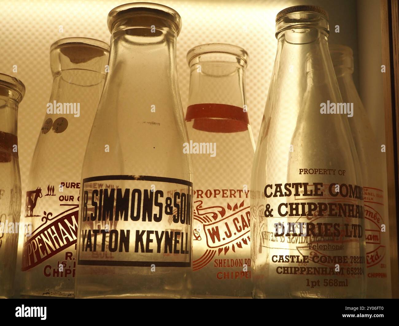 Selection of vintage glass milk bottles bearing name or names of dairy ...
