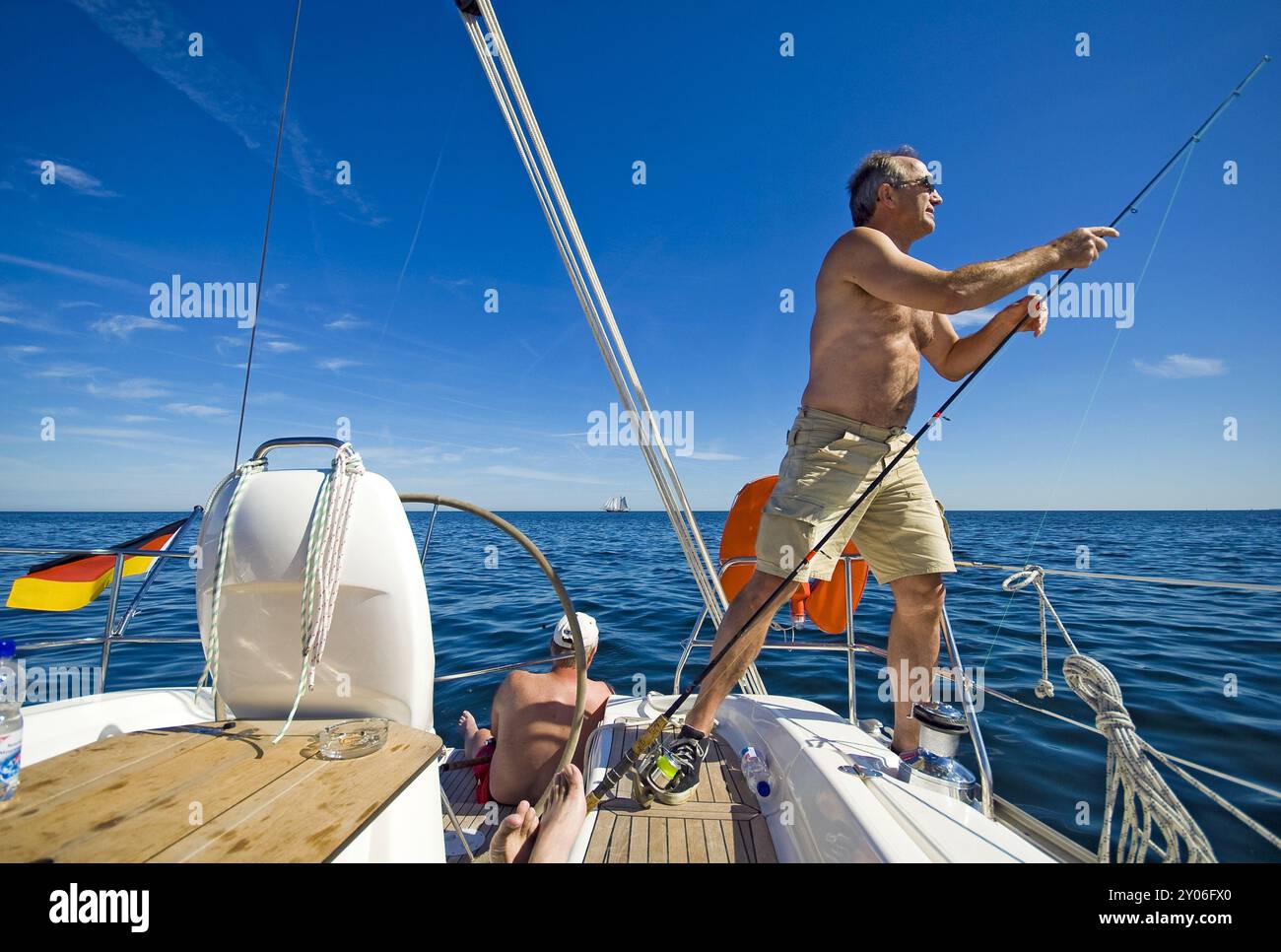 Deep-sea angler on board a sailing yacht Stock Photo - Alamy