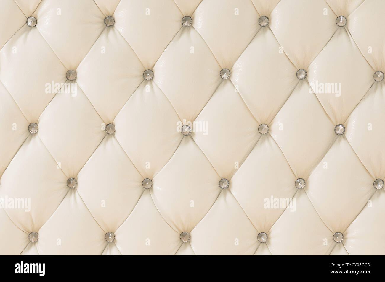 Beige soft tapestry pattern background with symmetrical buttons on the ...