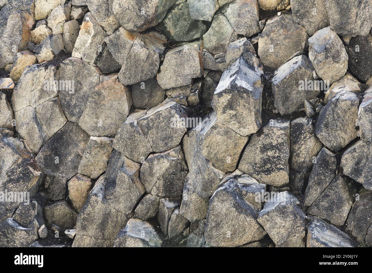 Textured basalt background hexagonal stone pillars in a section ...