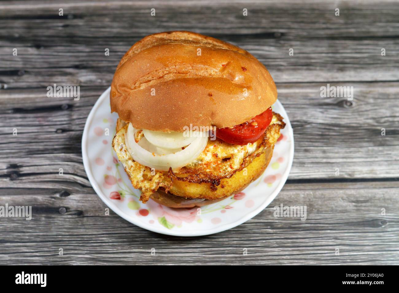fried chicken burger cooked in a boiling shallow oil with slices of ...