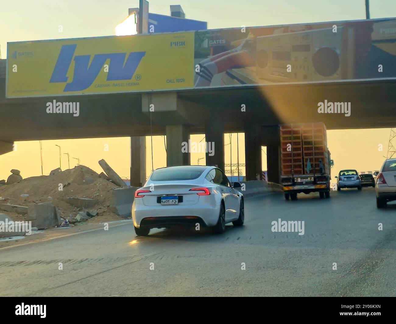 Giza, Egypt, August 9 2024: white Tesla car on the road, Tesla, Inc. is ...