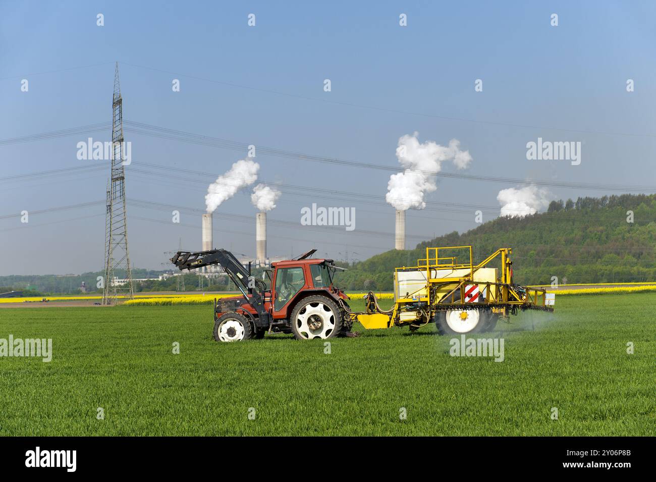 Tractor with trailer sprays crop protection agent on a grain field ...