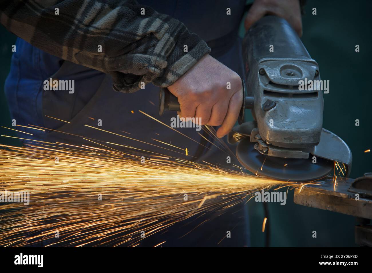 A worker's hands guide a cut-off machine Stock Photo - Alamy