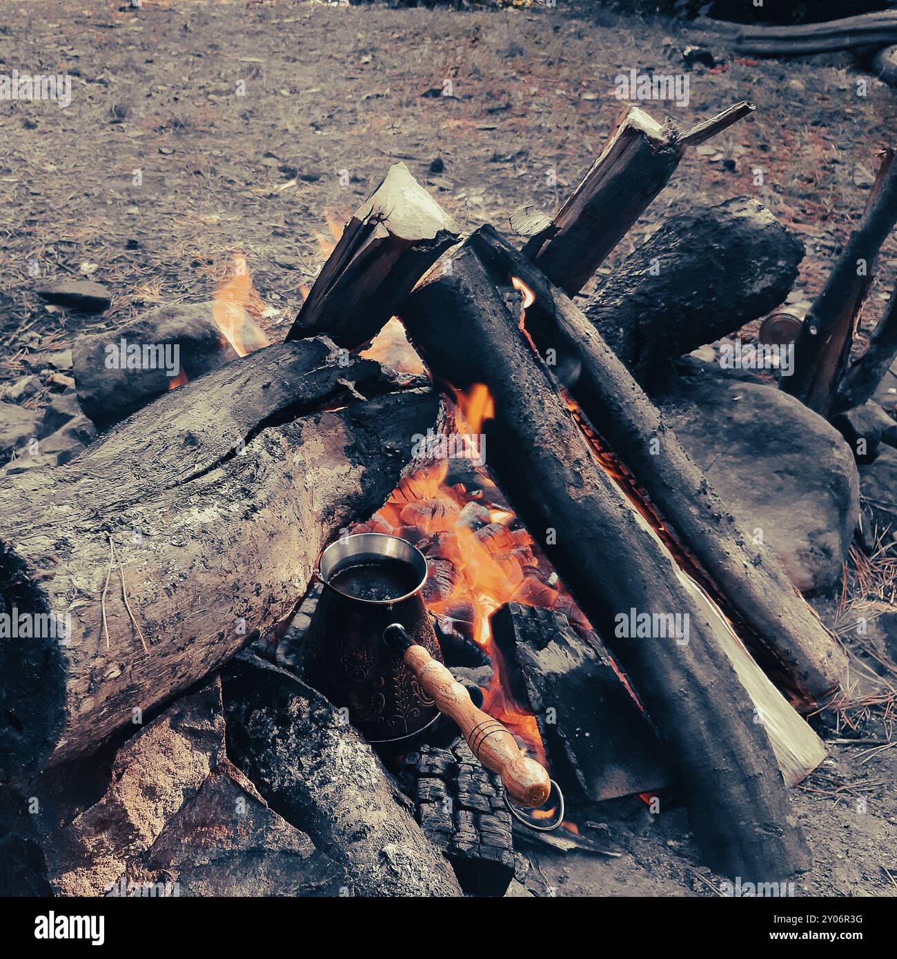 Brew coffee in a Turk on an open fire Stock Photo - Alamy