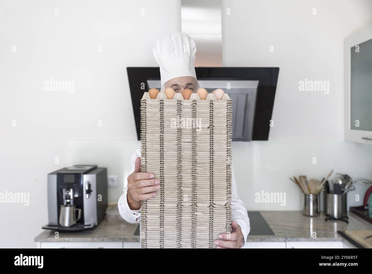 A stack of egg cartons and behind it the cook Stock Photo - Alamy