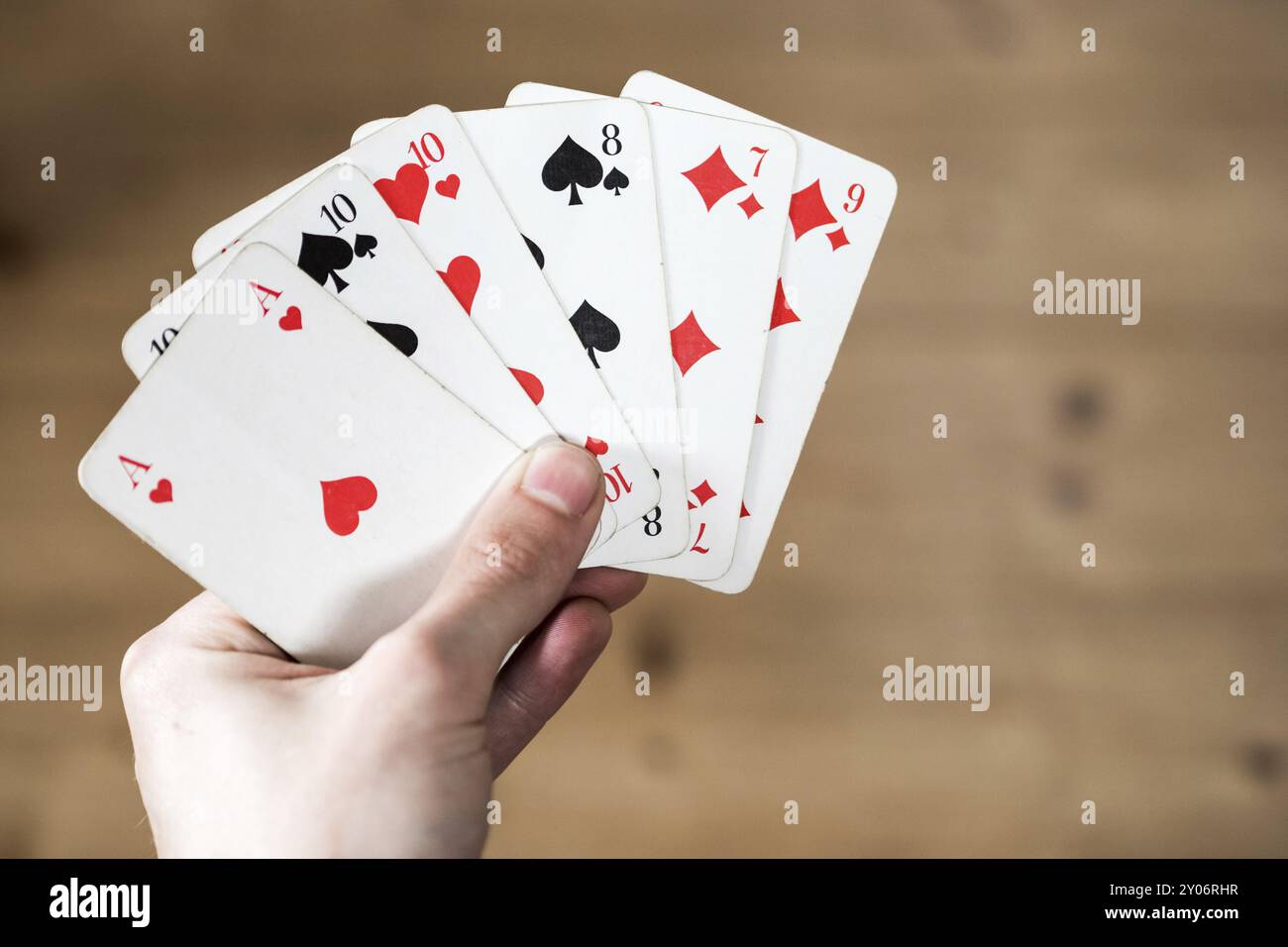 Man is playing cards, cutout of his hands Stock Photo - Alamy