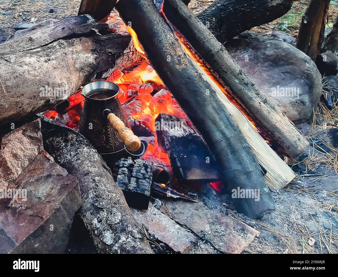 Brew coffee in a Turk on an open fire Stock Photo - Alamy