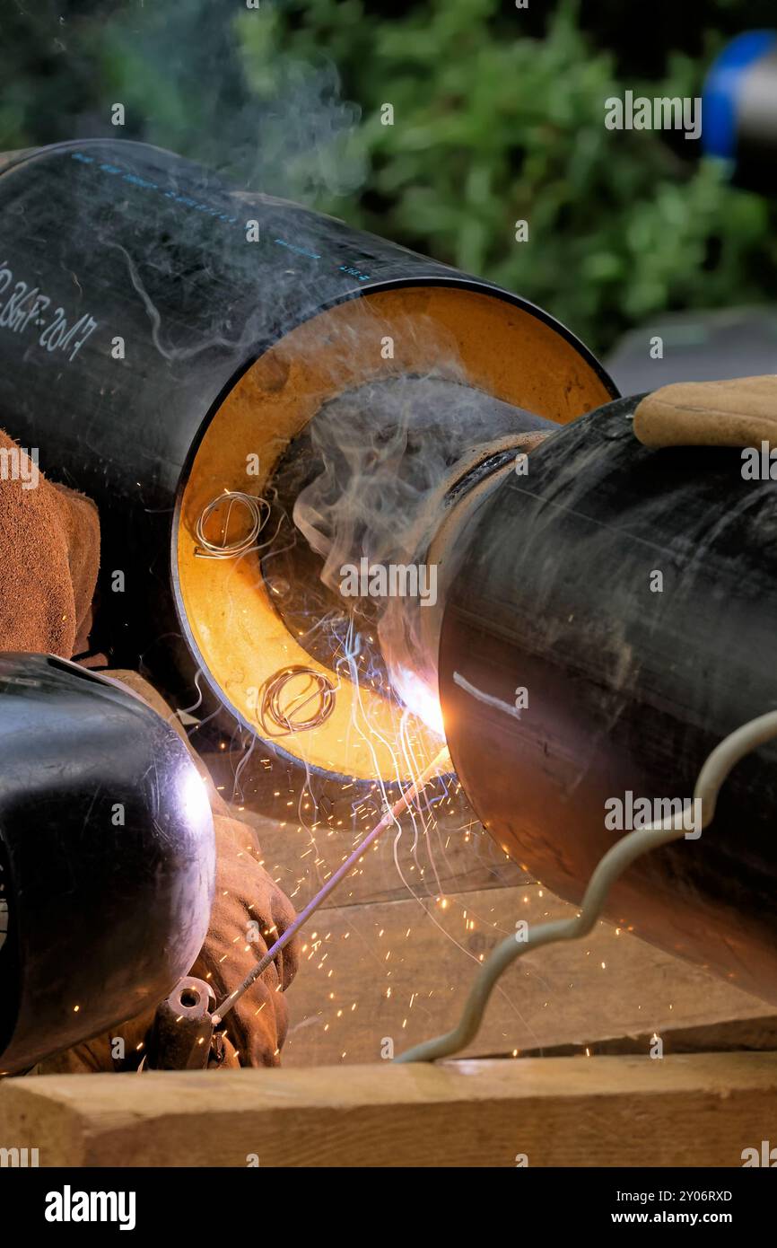 Welding district heating pipe Stock Photo - Alamy