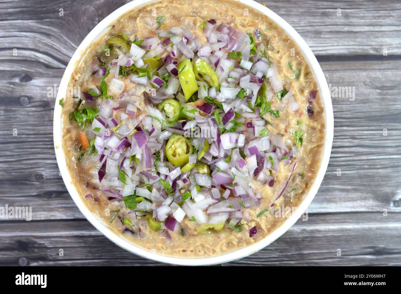 Mashed fava beans mixed with oil, sesame tahini, cumin, spices, slices ...