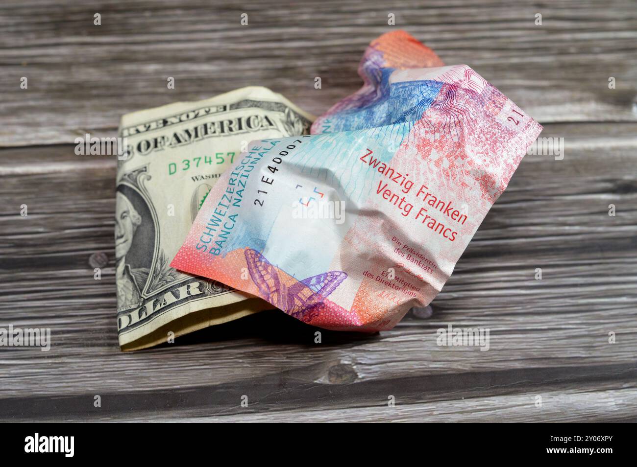 American USD dollar crumpled banknote with Swiss CHF francs wrinkled ...