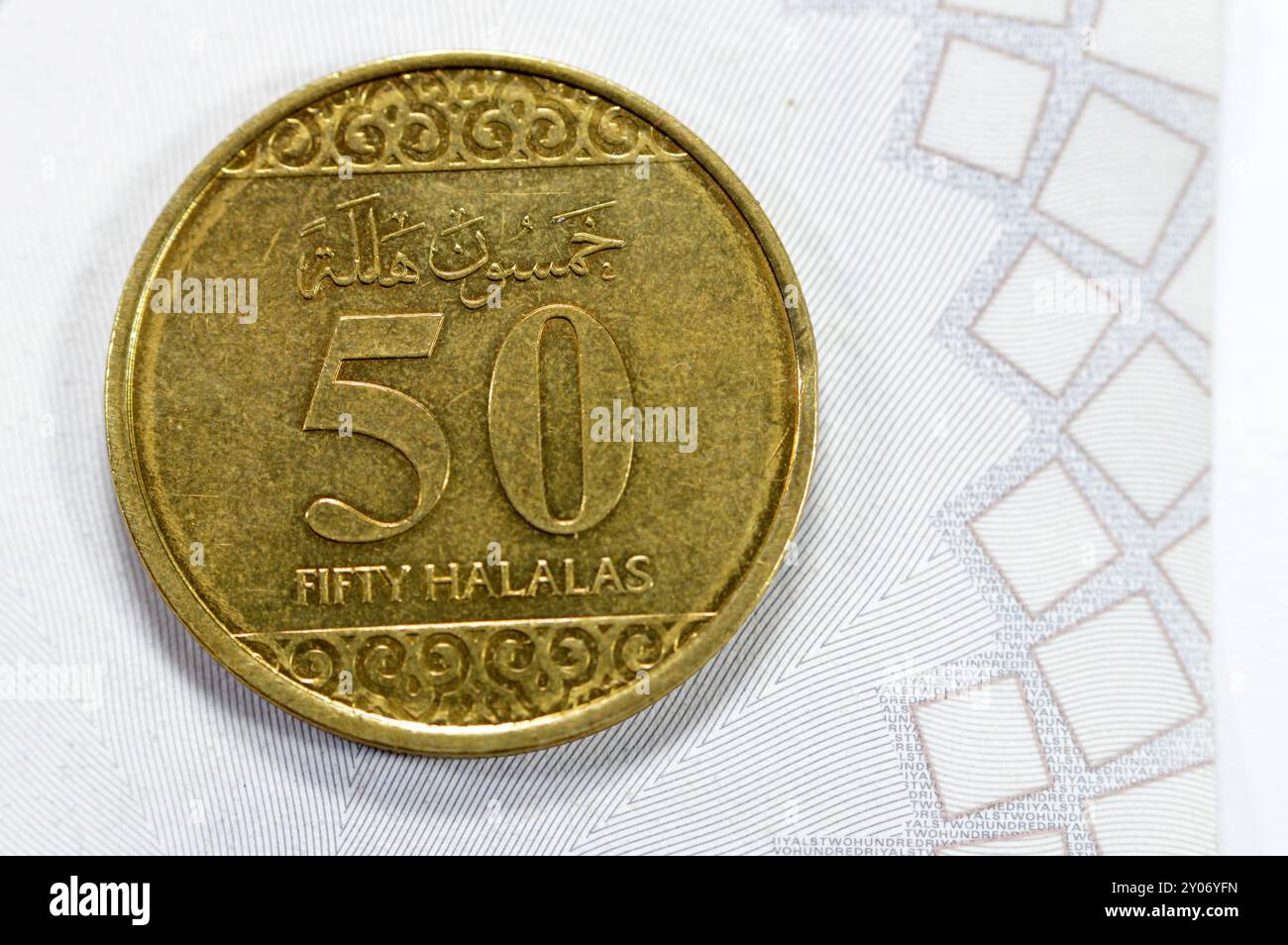 Half riyal golden coin 50 fifty Halalas, features trefoil floral ...