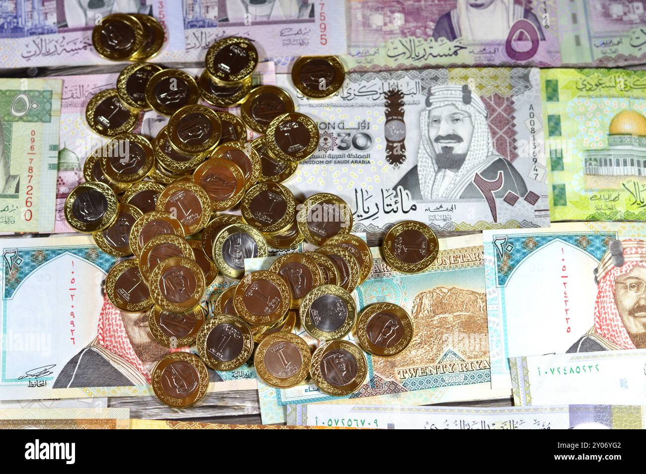 Coins of one Saudi Arabian riyal on Saudi Arabia money banknotes of ...