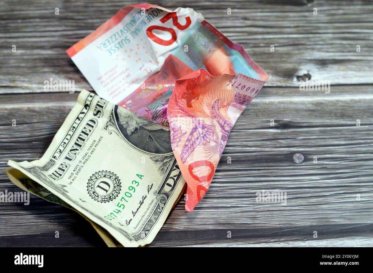 American USD dollar crumpled banknote with Swiss CHF francs wrinkled ...