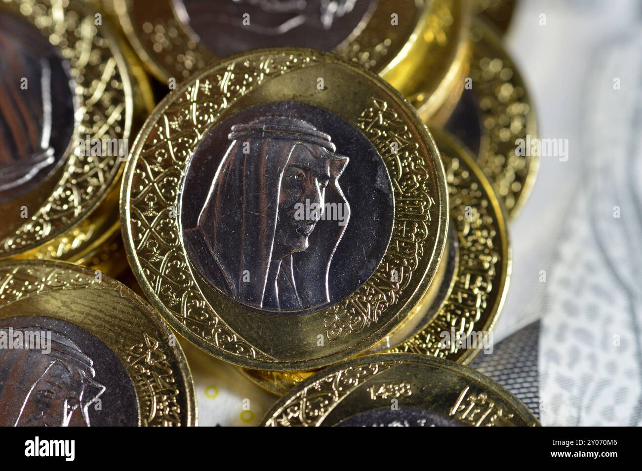 Pile of 1 one Saudi Arabia riyal coin currency features king Salman on ...