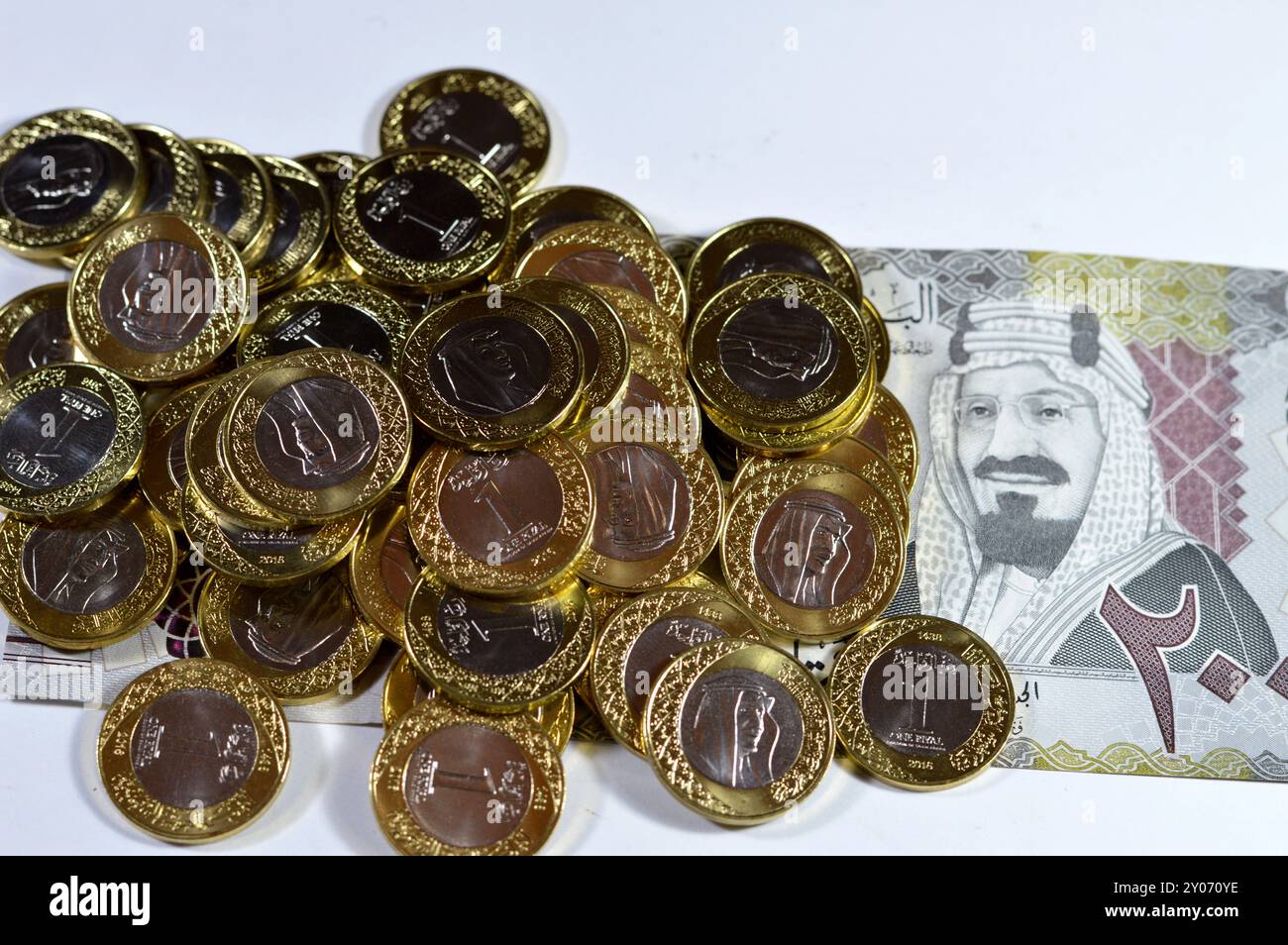 Pile of 1 one Saudi Arabia riyal coin currency features king Salman on ...