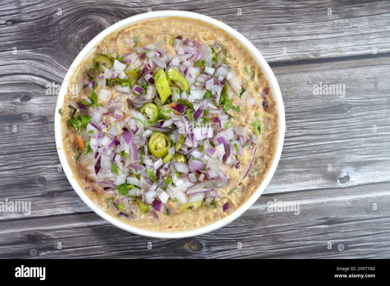 Mashed fava beans mixed with oil, sesame tahini, cumin, spices, slices ...