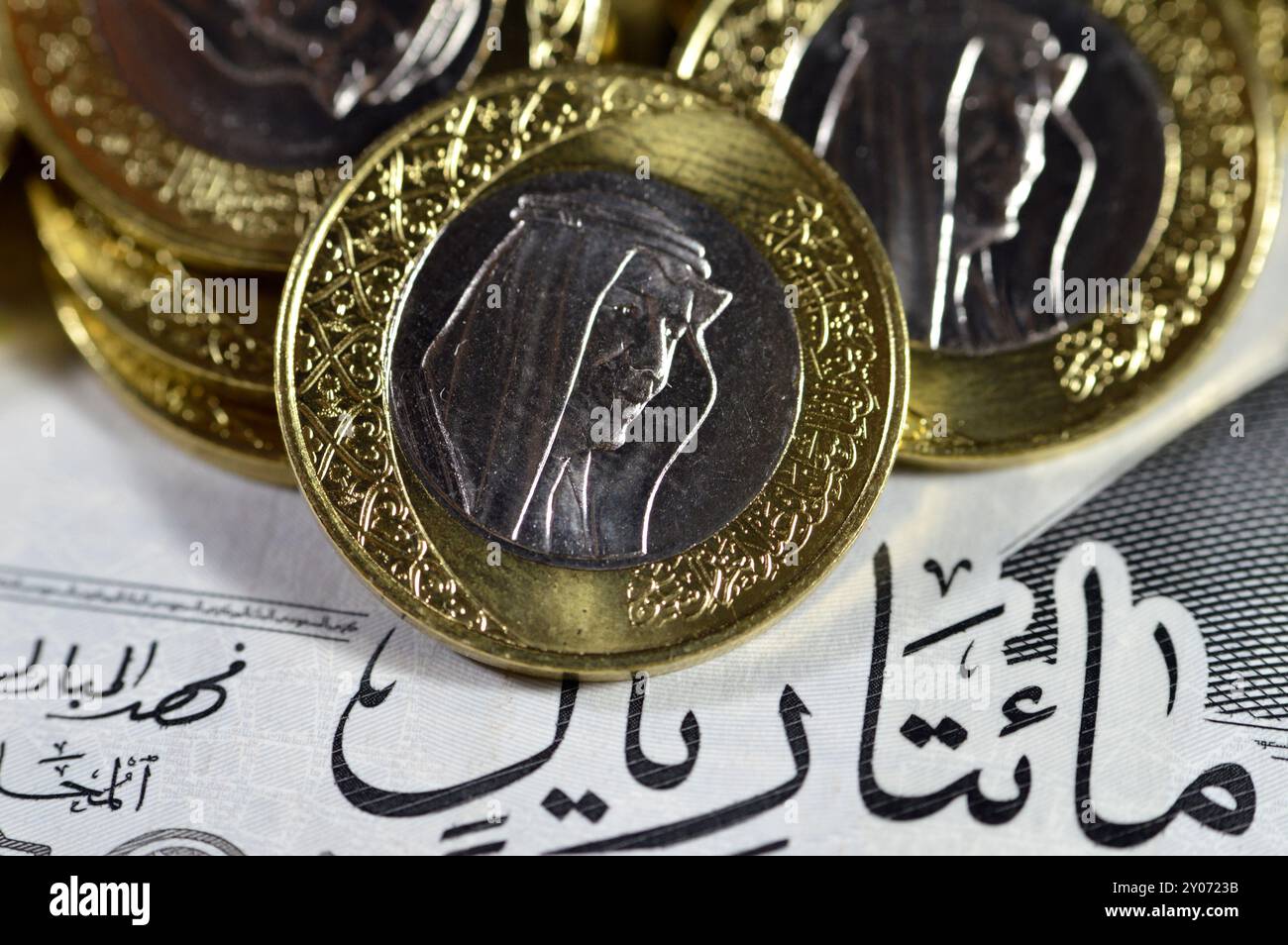 Pile of 1 one Saudi Arabia riyal coin currency features king Salman on ...