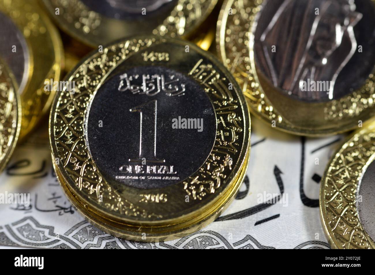 Pile of 1 one Saudi Arabia riyal coin currency features king Salman on ...