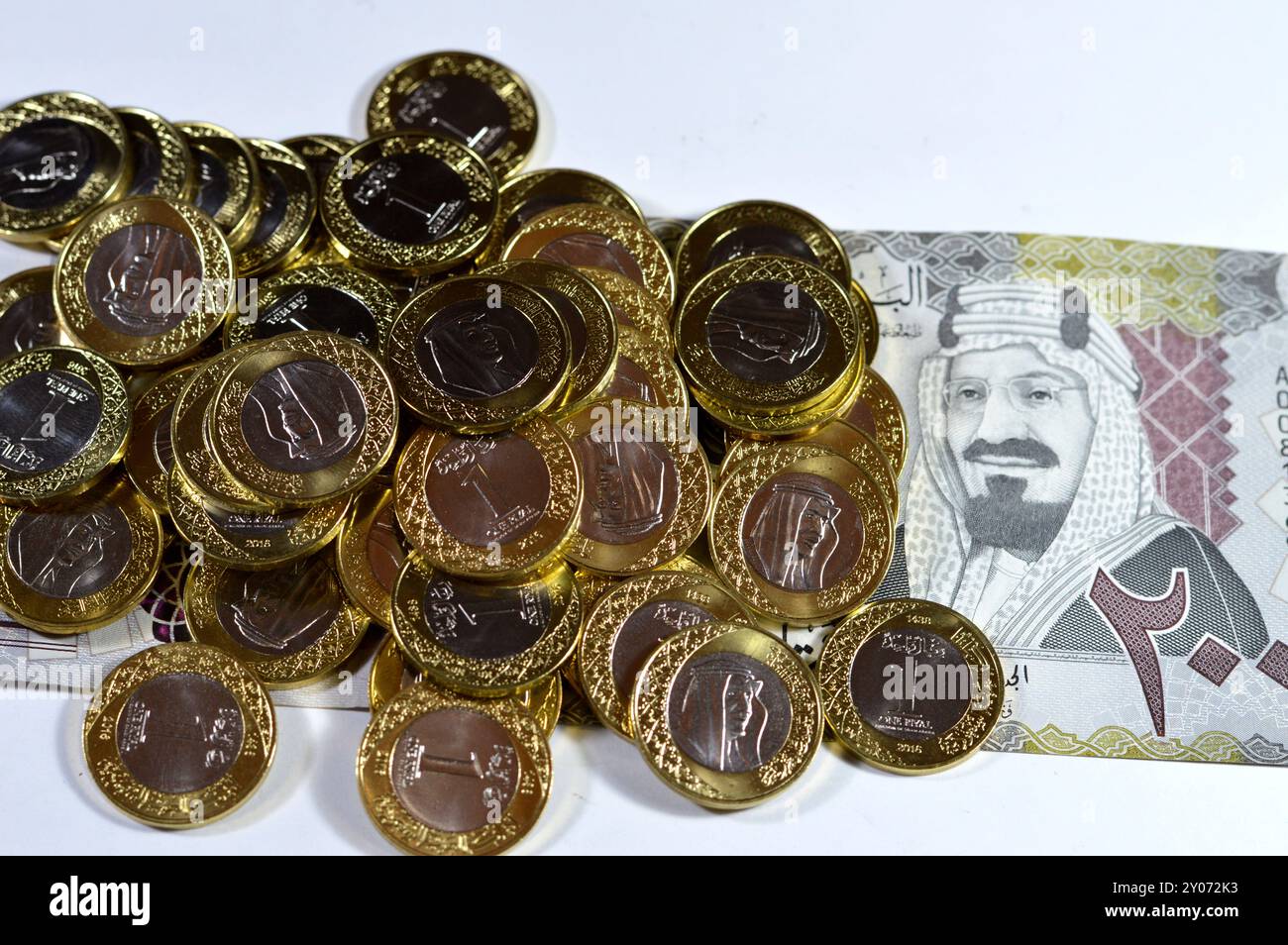 Pile of 1 one Saudi Arabia riyal coin currency features king Salman on ...
