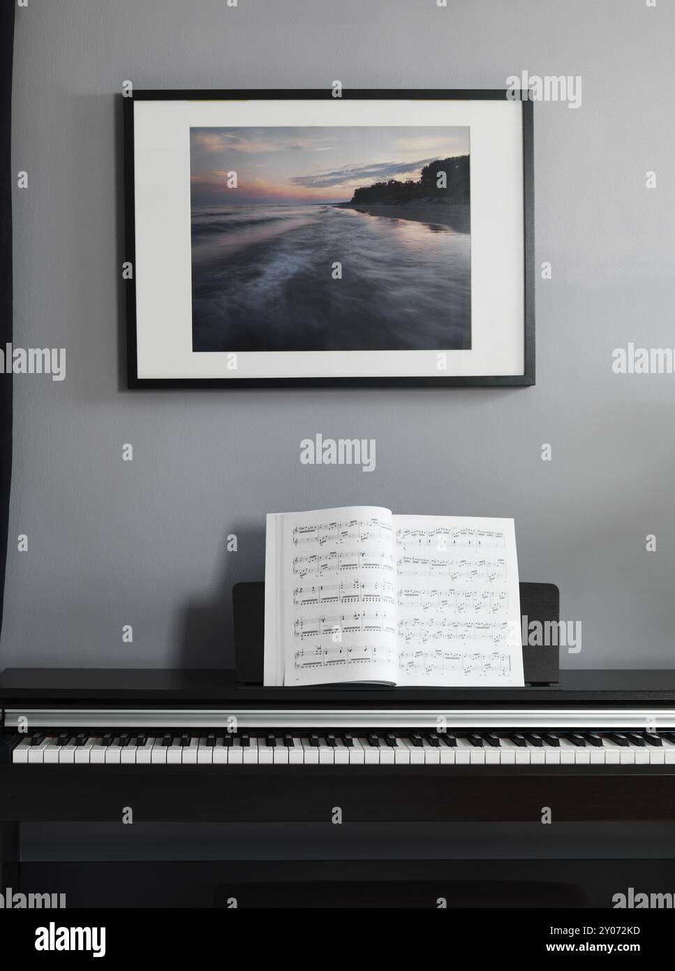 Digital piano keyboard with music scores in a room interior Stock Photo ...