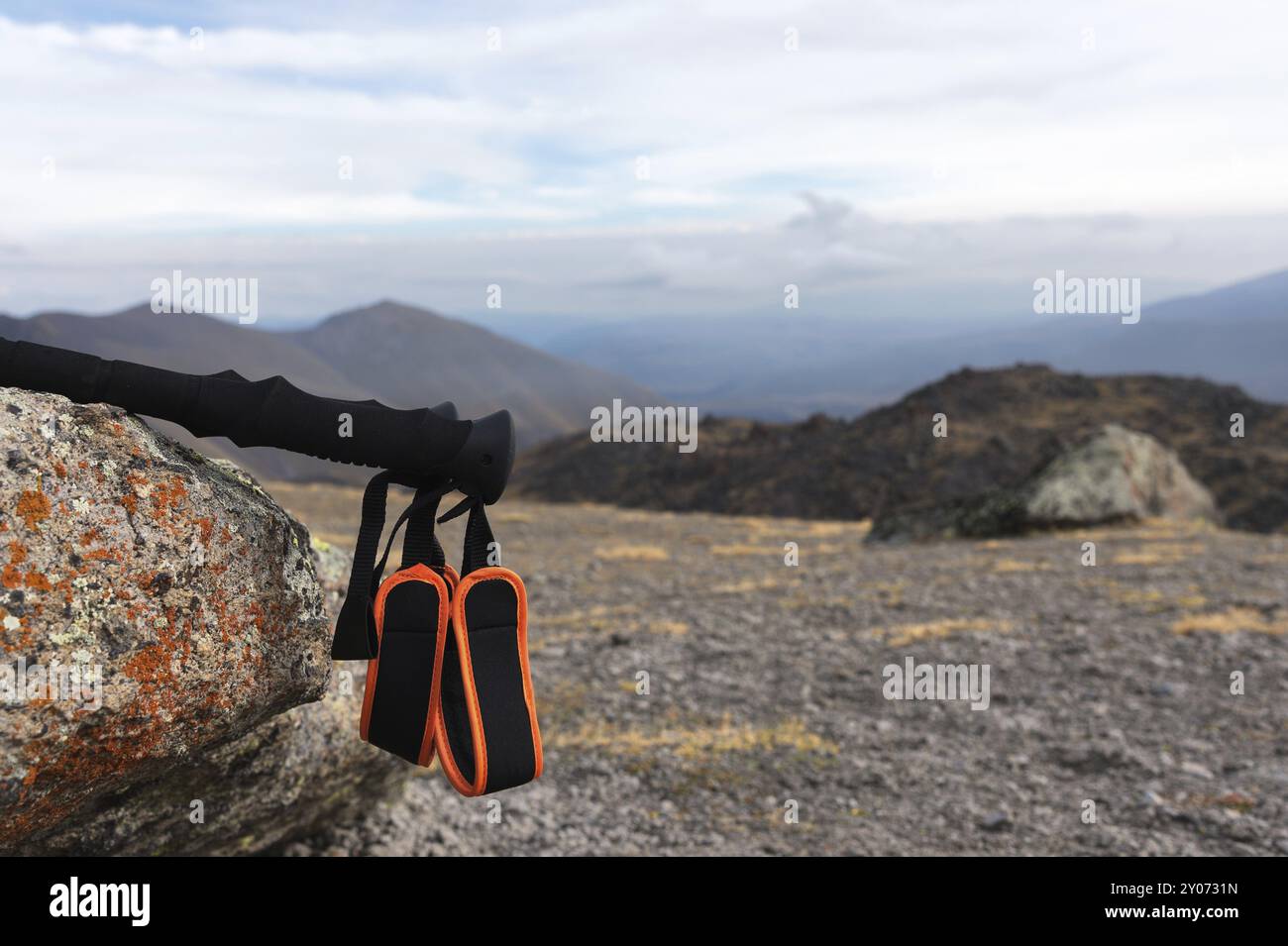 Professional sticks for climbing a mountain near a stone on a high ...