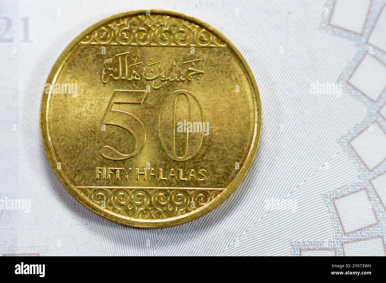 Half riyal golden coin 50 fifty Halalas, features trefoil floral ...