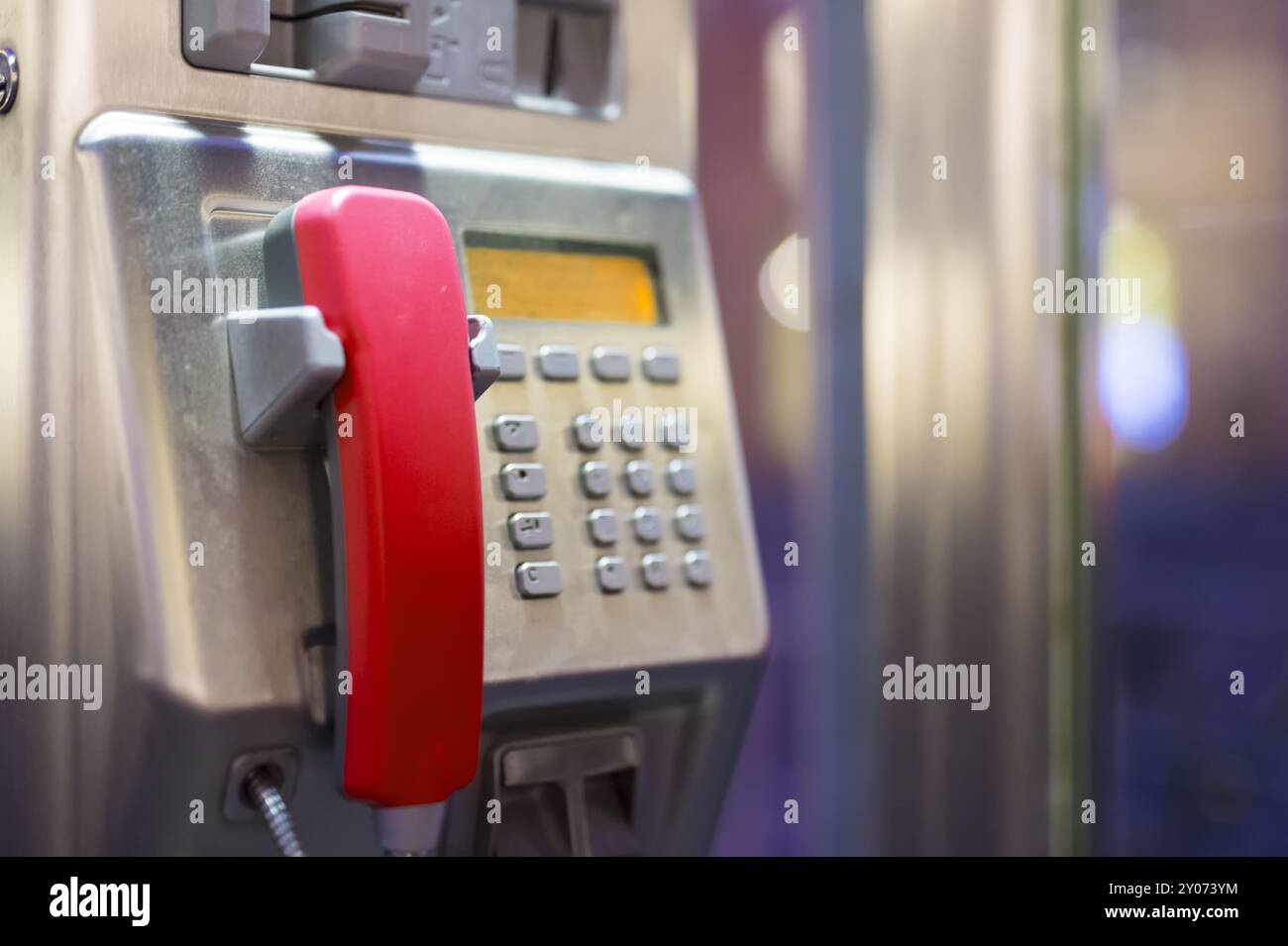 Handset and keypad of an old payphone at night Stock Photo - Alamy