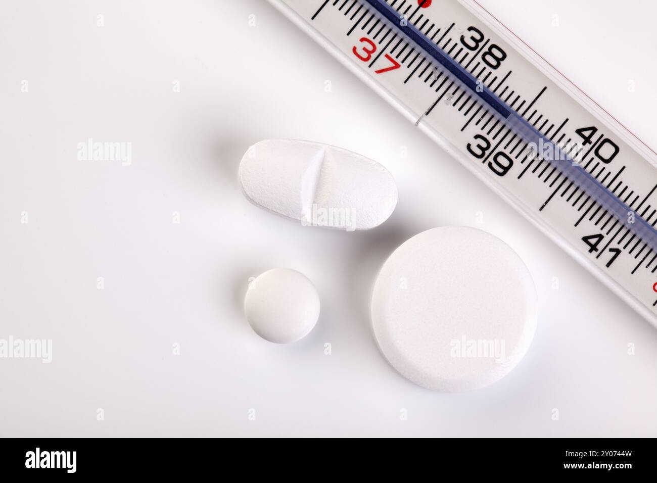 Clinical thermometer at 39 degrees Celsius and various tablets Stock ...