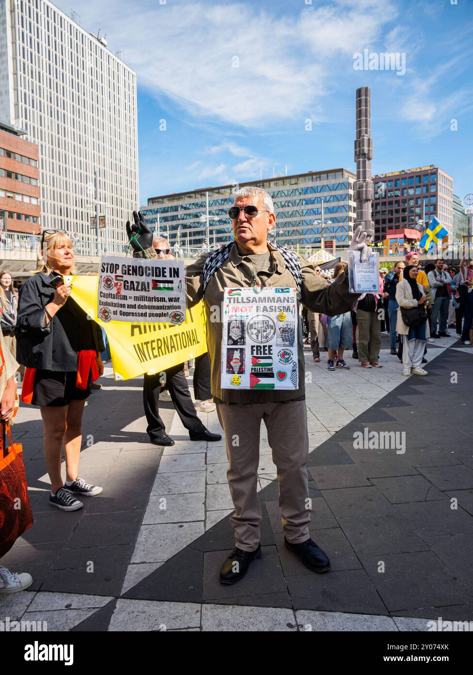 Stockholm, Sweden - August 24, 2024: A man holds signs supporting ...
