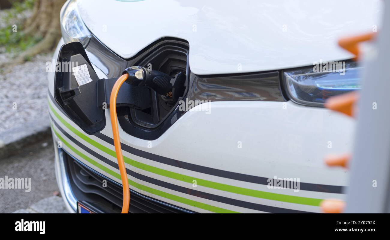 Electric car recharging with charge cable and plug leading to charge ...