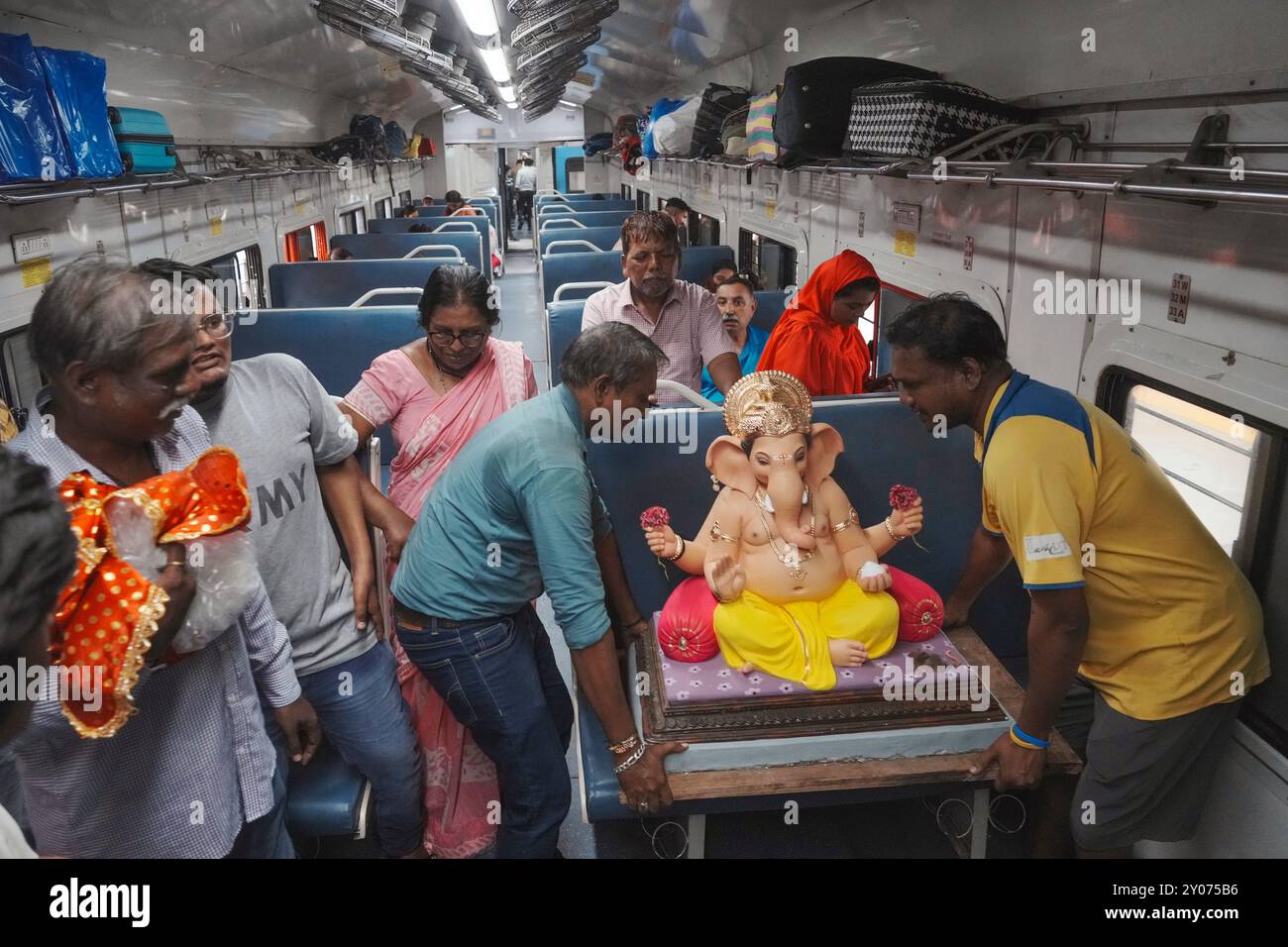 A clay idol of elephant headed Hindu god Ganesha is carried onto a ...