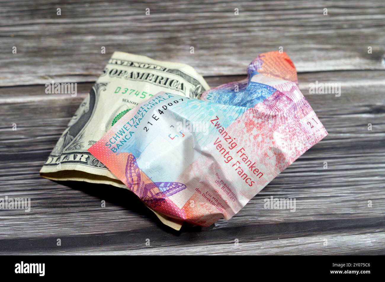 American USD dollar crumpled banknote with Swiss CHF francs wrinkled ...