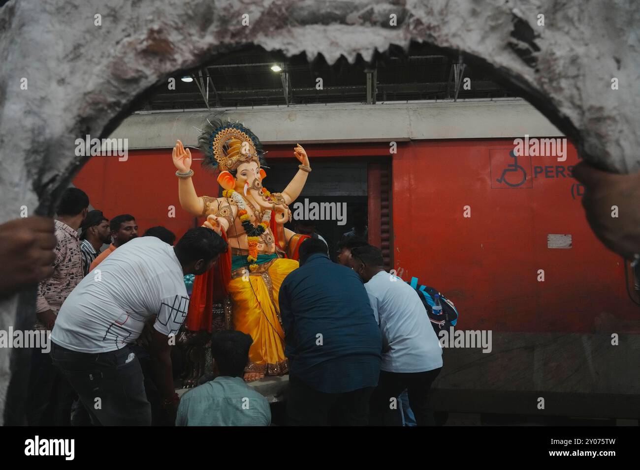 A clay idol of elephant headed Hindu god Ganesha is carried onto a ...