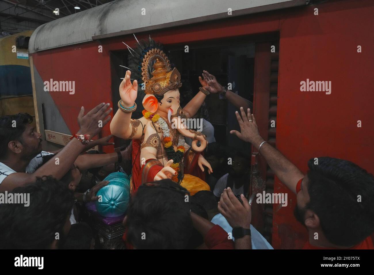 A clay idol of elephant headed Hindu god Ganesha is carried onto a ...