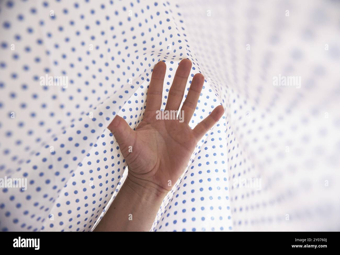 Hand under the duvet Stock Photo - Alamy