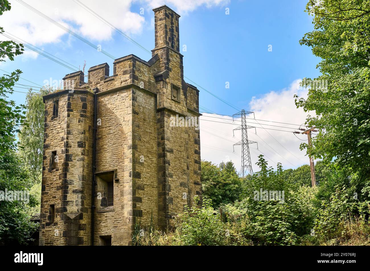 Stone tower of medieval origin and electricity pylon and lines ...