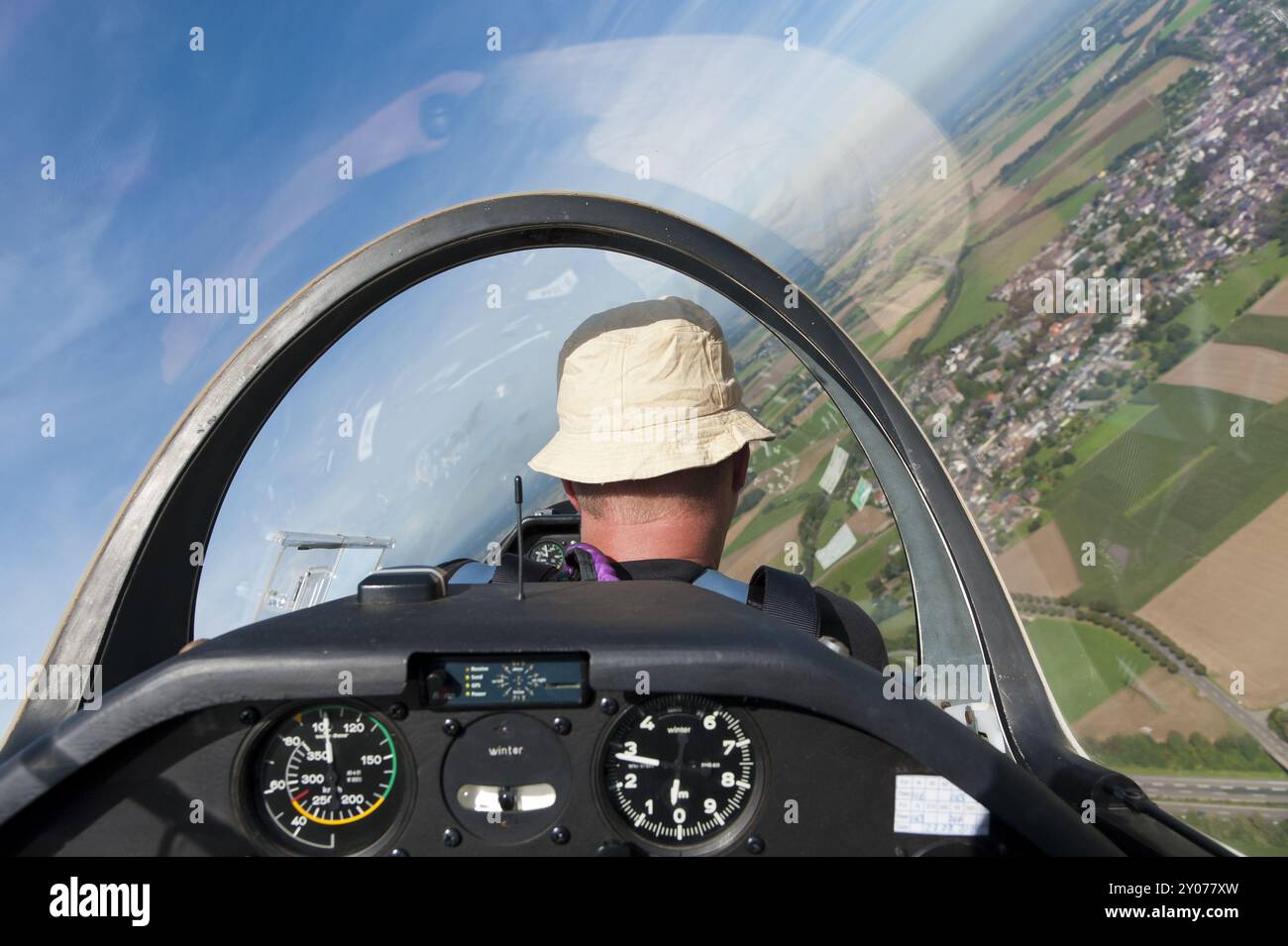 Glider pilot in a glider over a small town Stock Photo - Alamy