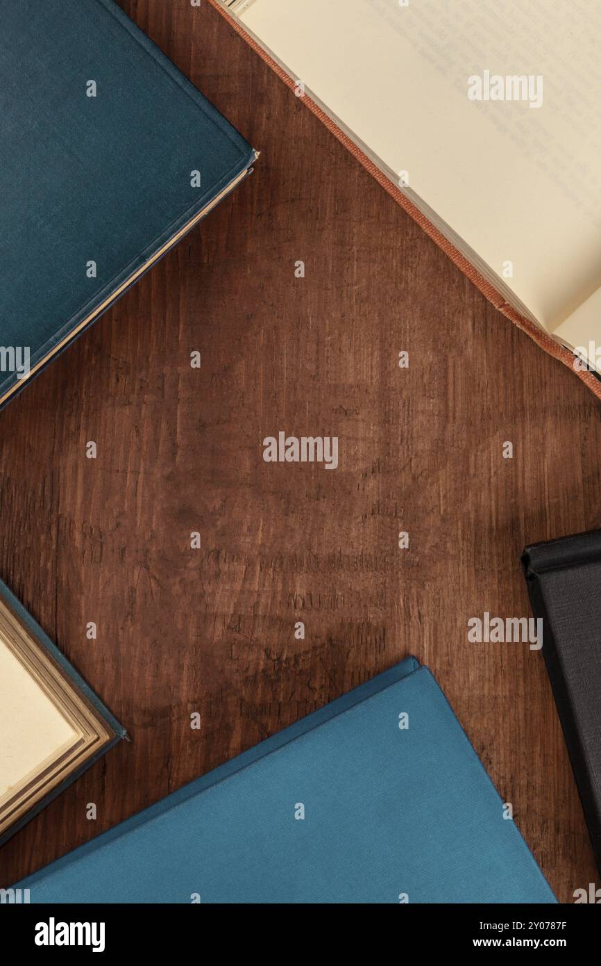 An overhead photo of old books, shot from above on a dark background ...