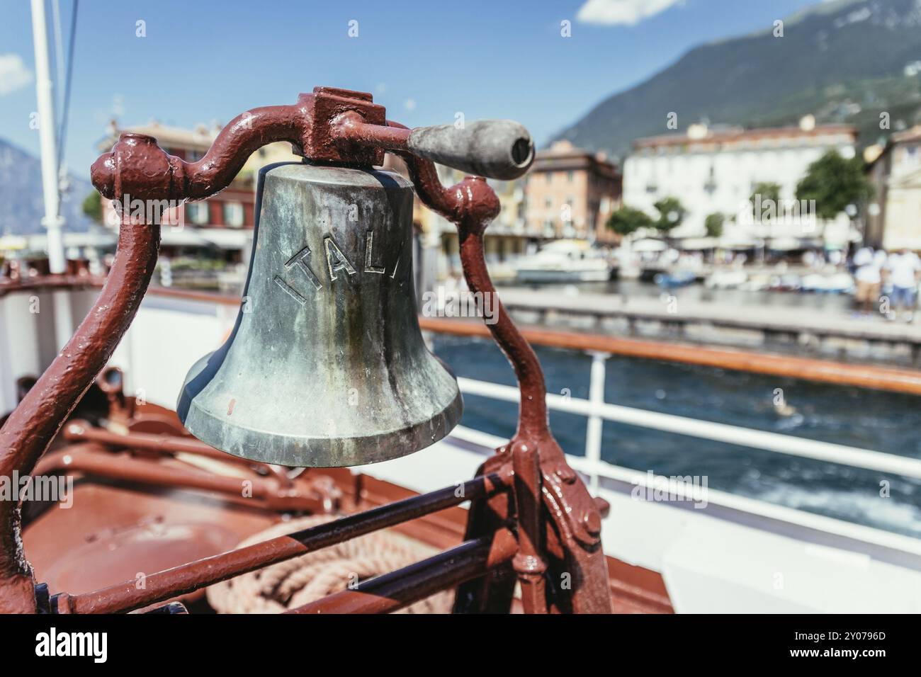 Bow of a boat with boat bell on a cruise tour. Blue water, mountain ...