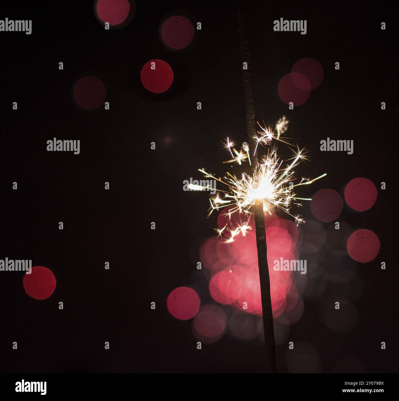 Celebration sparklers lighting up night hi-res stock photography and ...