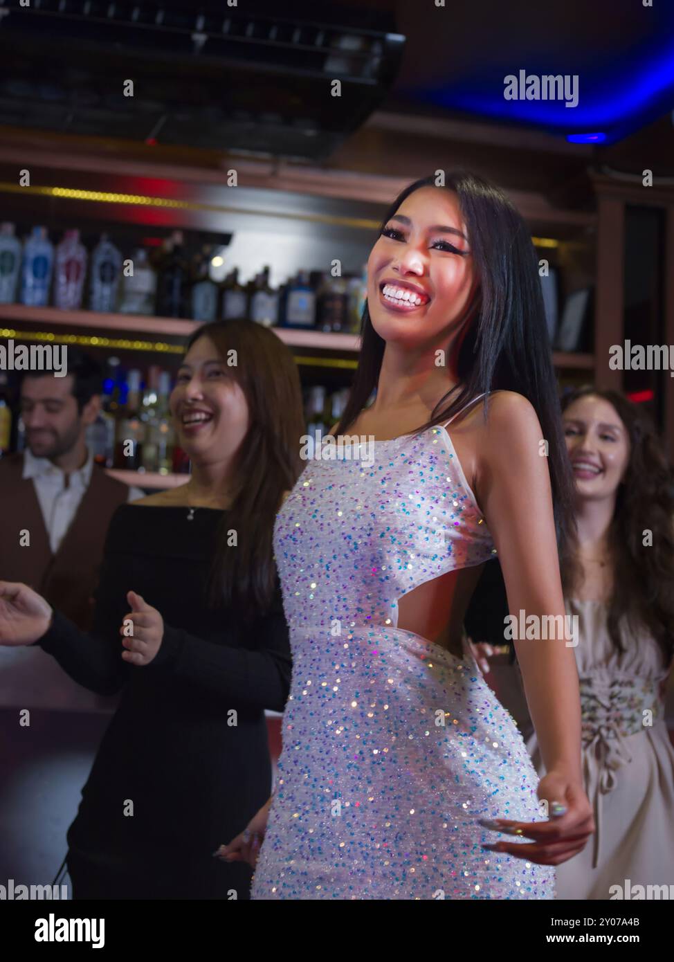 Happy young women dancing and partying with friends at nightclub. Event ...