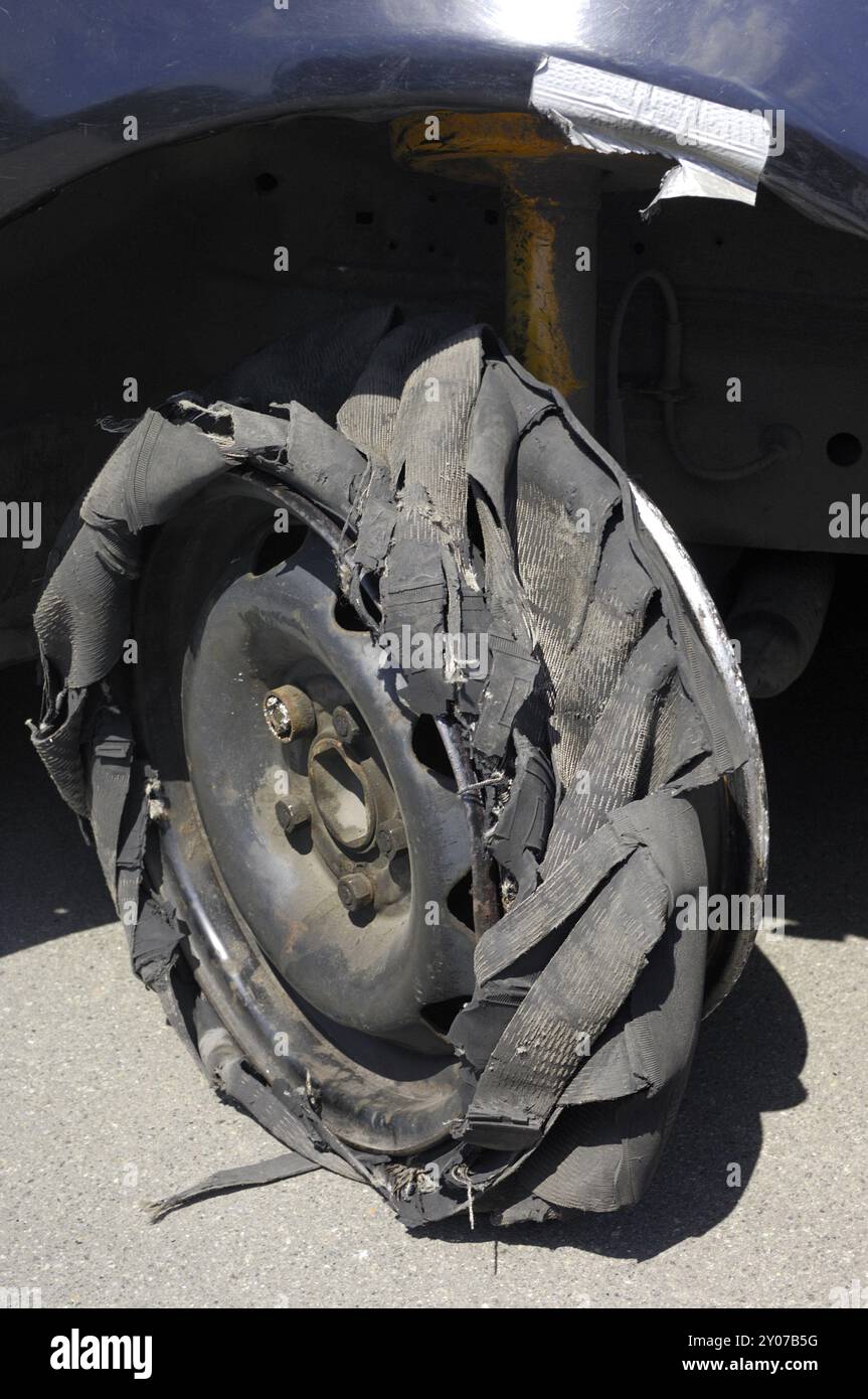 Tore shredded into pieces tire on a damaged car wheel Stock Photo - Alamy