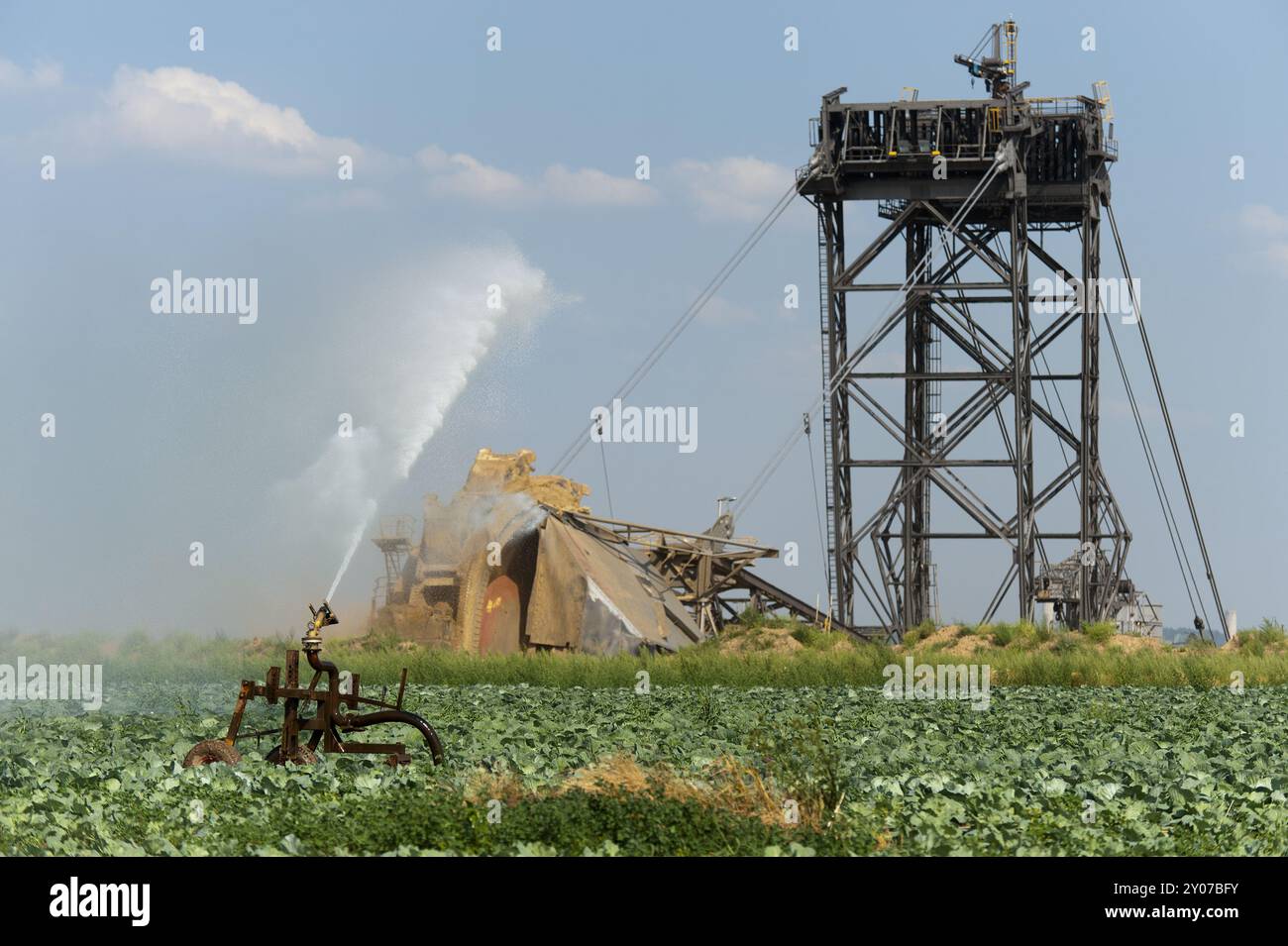 Agriculture sprinkler system in front of a bucket wheel excavator Stock ...
