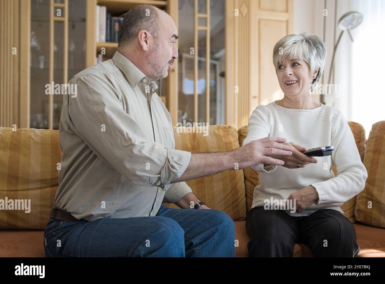 Couple and remote control Stock Photo - Alamy