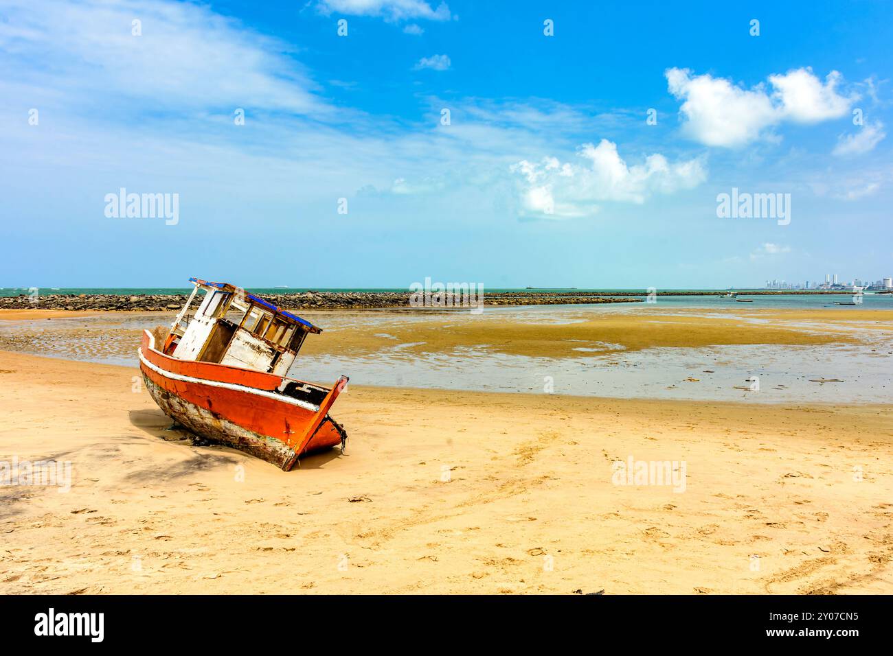 Abandoned and deteriorated fishing trawler stranded on the beach sand ...